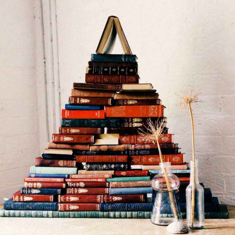 a holiday tree made of stacked vintage books - Improvised Life